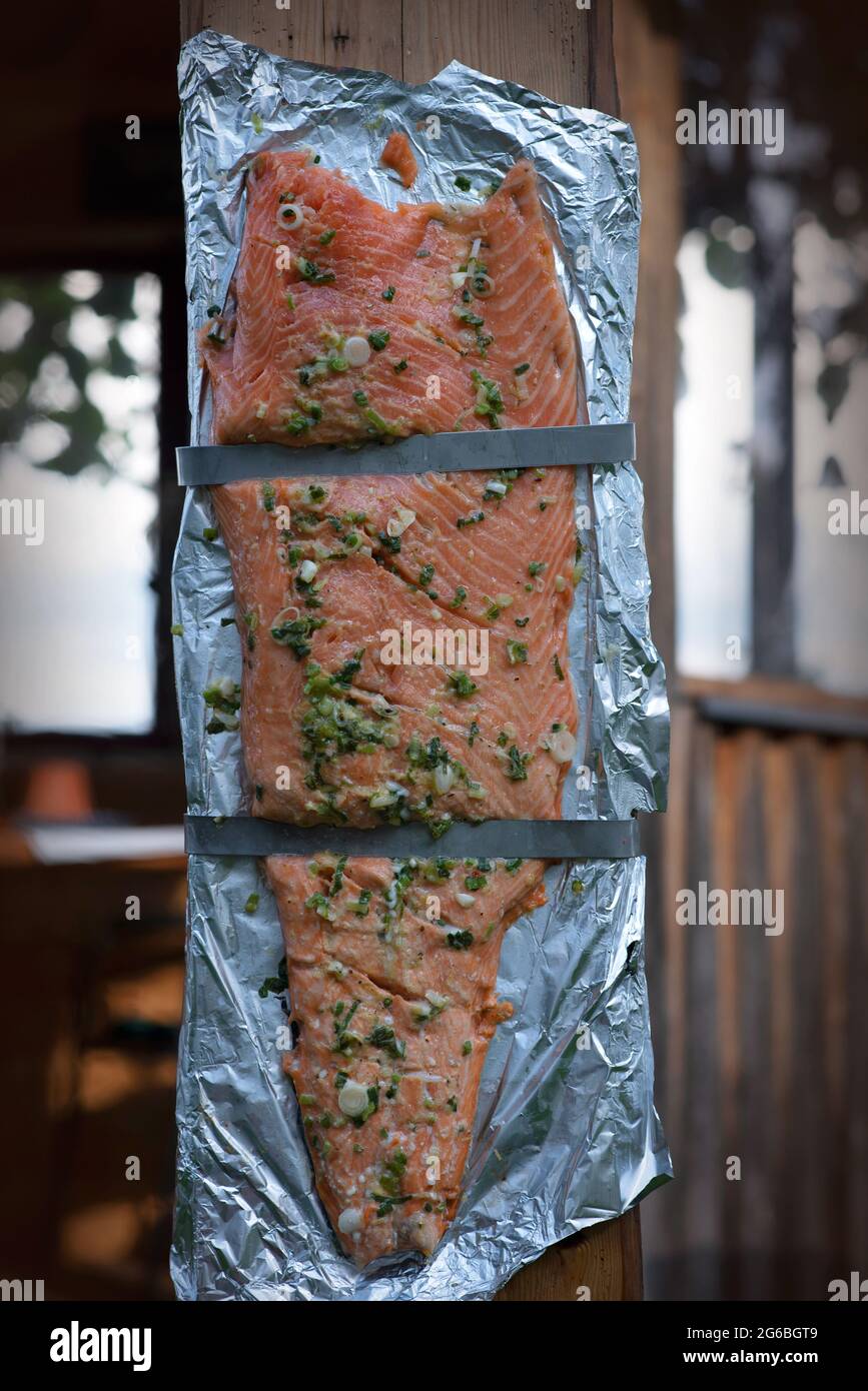 Traditional fish dish, Smoked salmon or trout on a wooden plank ...