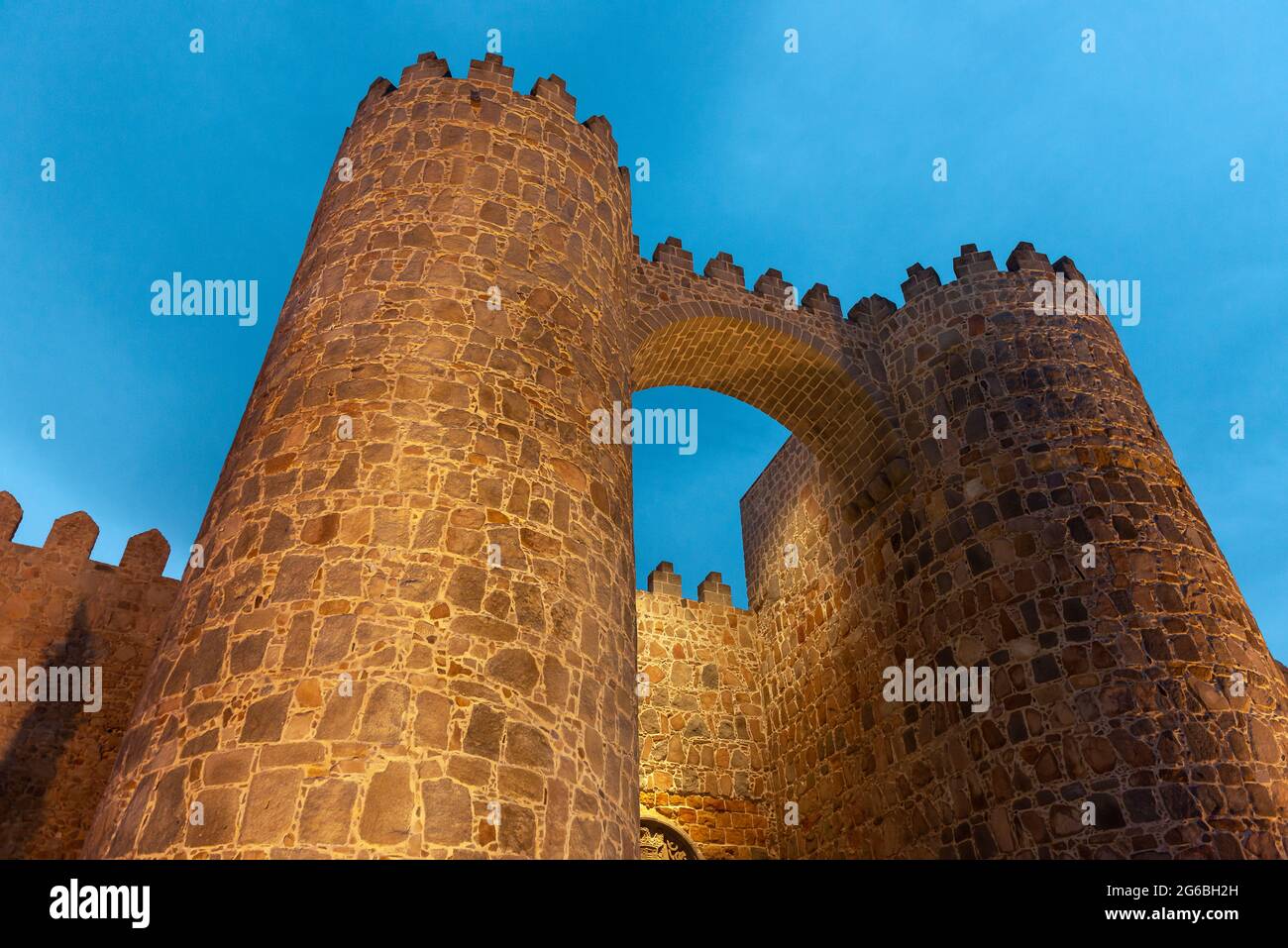 Alcazar Gate of the medieval city wall of Avila at dusk, Spain Stock ...