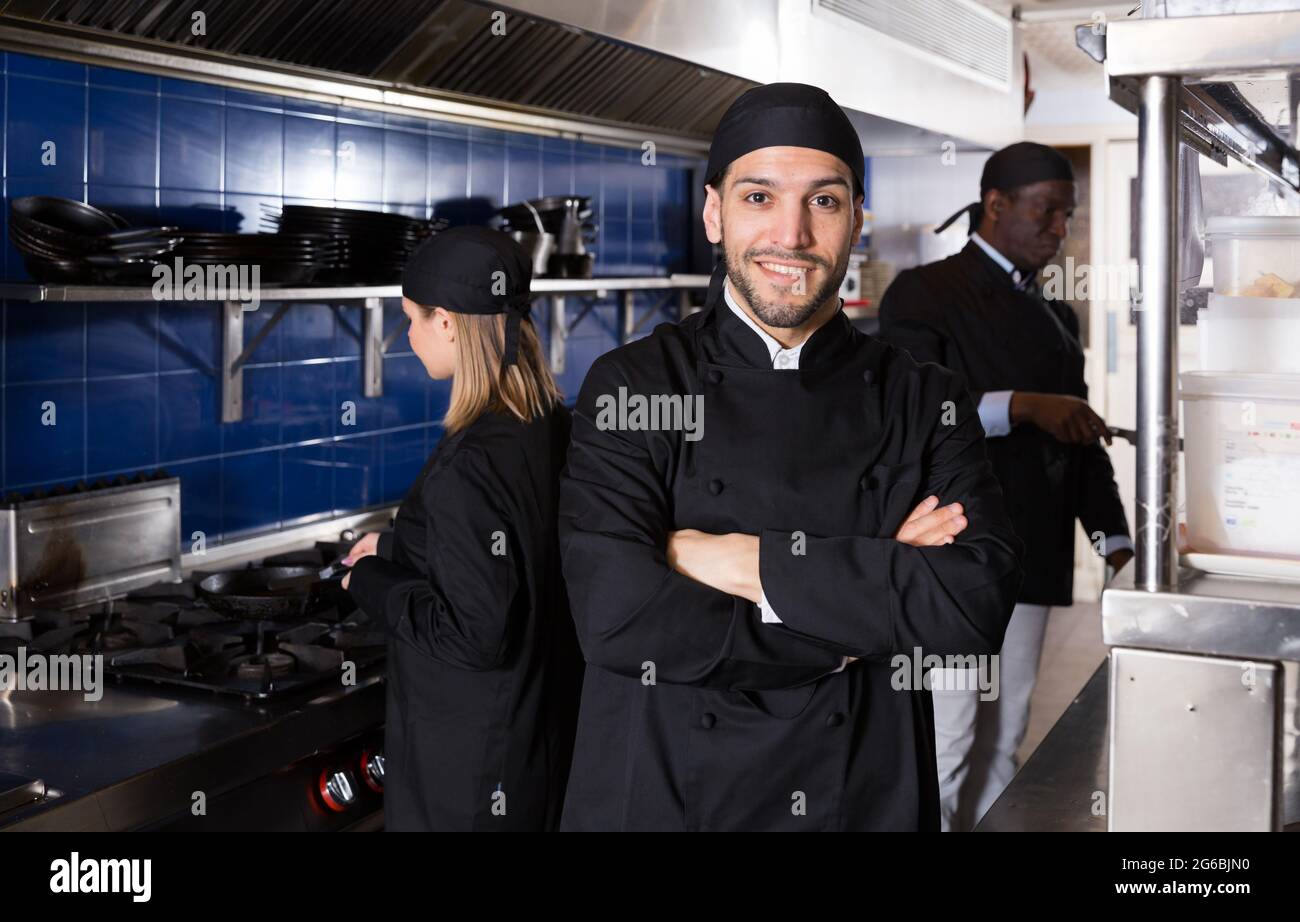 Confident chef in restaurant kitchen Stock Photo - Alamy