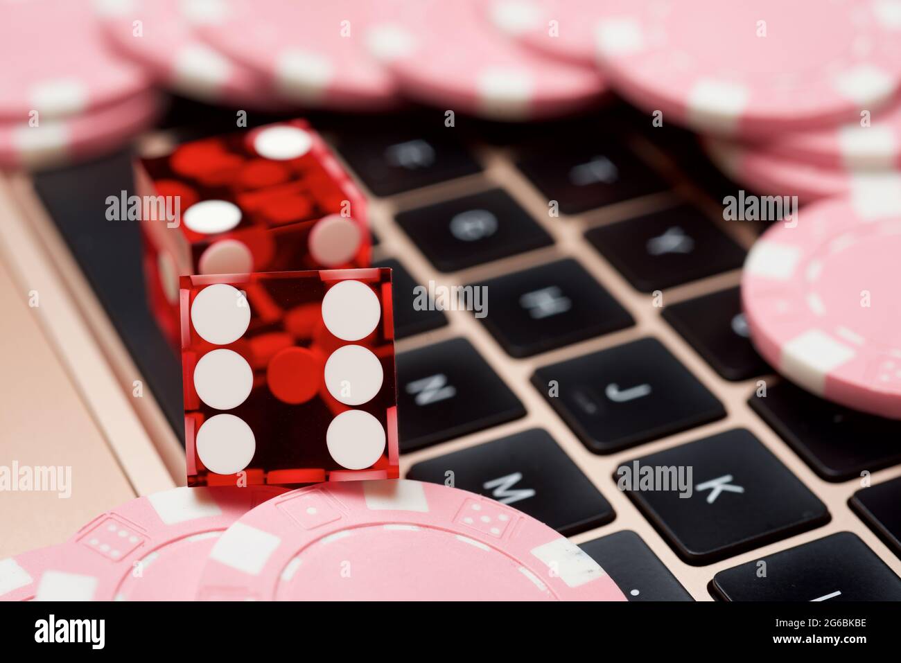 Casino chips and dices stacking on a laptop Stock Photo - Alamy