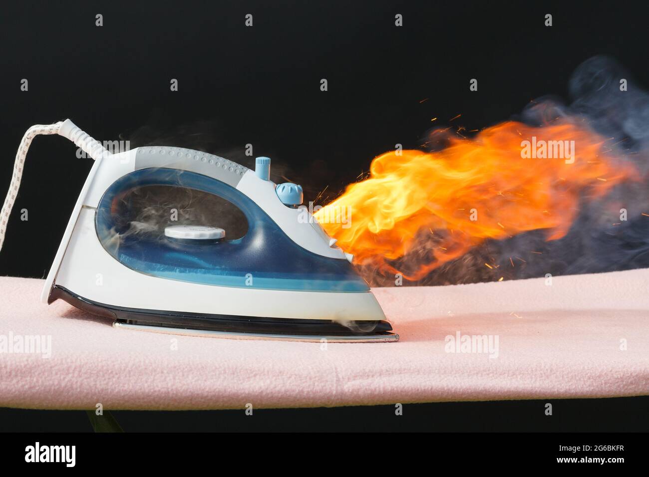 Iron in flames of fire, faulty wiring, cause of fire Stock Photo - Alamy