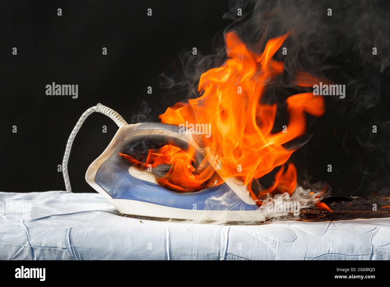 On the ironing board fire caused by faulty electrical wiring Stock ...