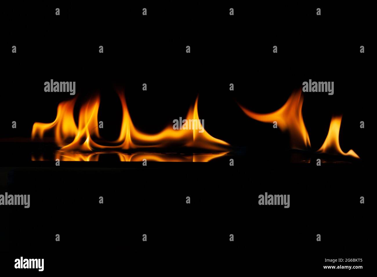 fire flame with reflection in the glass on a black background selective ...