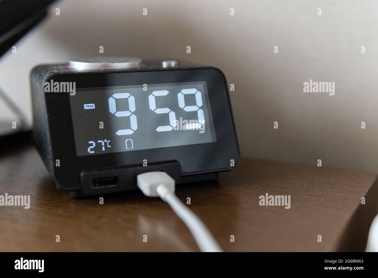 A digital clock on table showing 9.59 am morning Stock Photo - Alamy