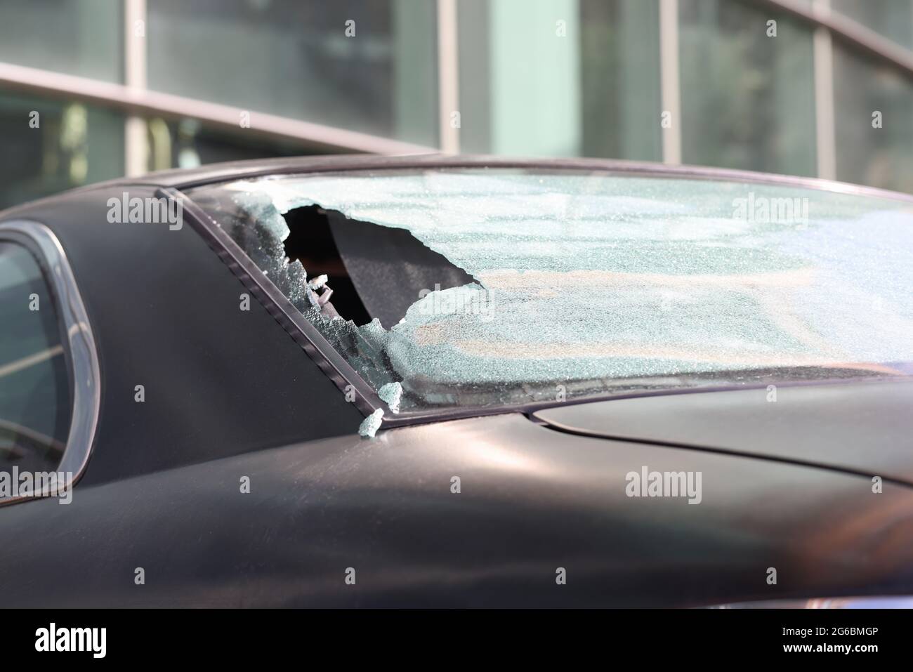 Closeup of hole in rear window of car Stock Photo - Alamy