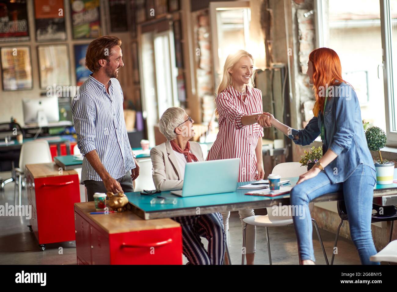 A young woman introducing herself to colleagues in a friendly ...