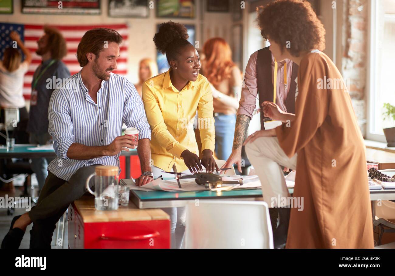 Group of young people in a creative process at work in a pleasant ...