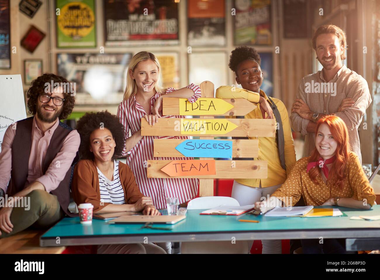 Group of young creative employees are posing for a photo and promoting ...