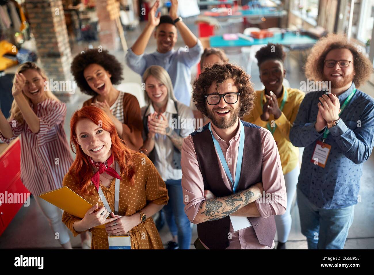 Group of young creative people at work is clapping and yelling while ...