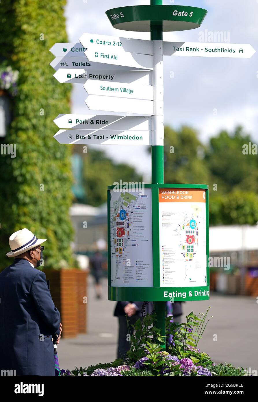 A spectator checks the map by gate 5 ahead of day seven of Wimbledon at ...