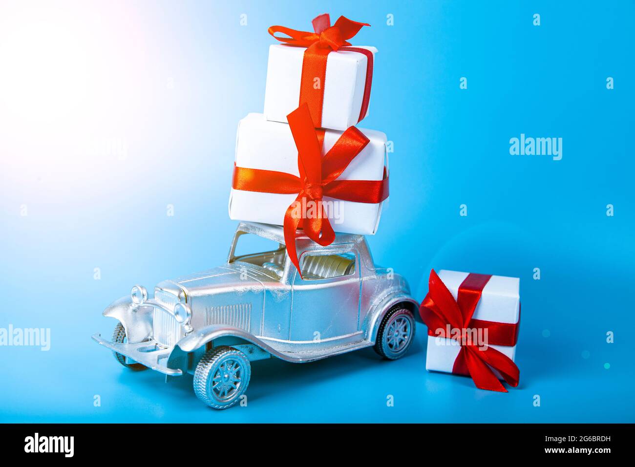 Silver car with gifts on a blue background. Buying a car Stock Photo ...
