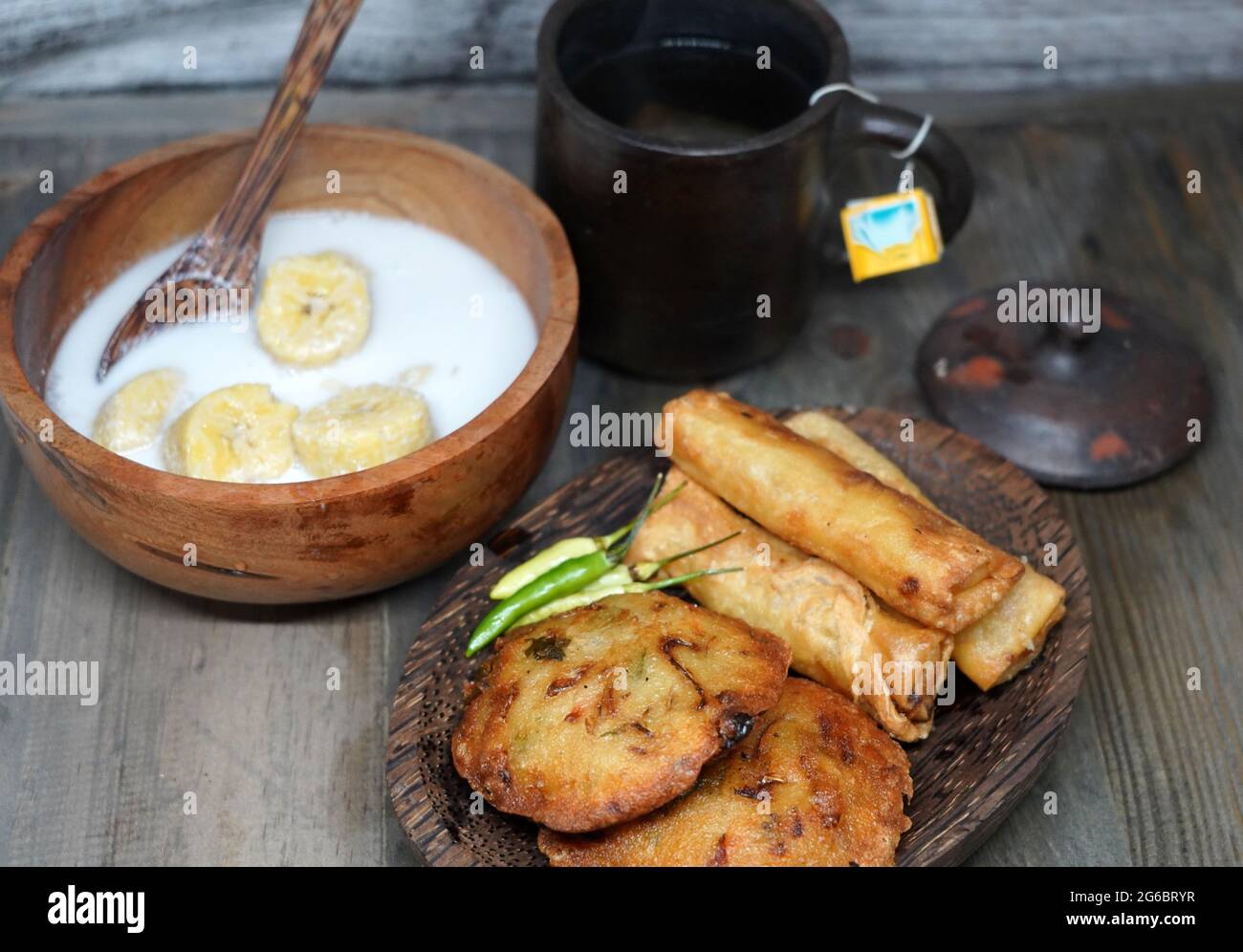 Breakfast with snacks and tea on wooden table Stock Photo - Alamy