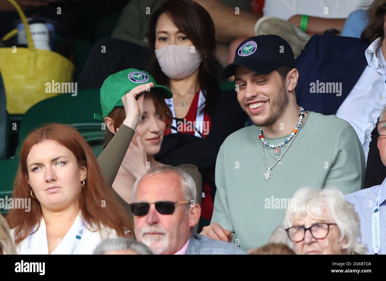 London, UK. 03rd July, 2021. Phoebe Dynevor puts on a cap alongside ...