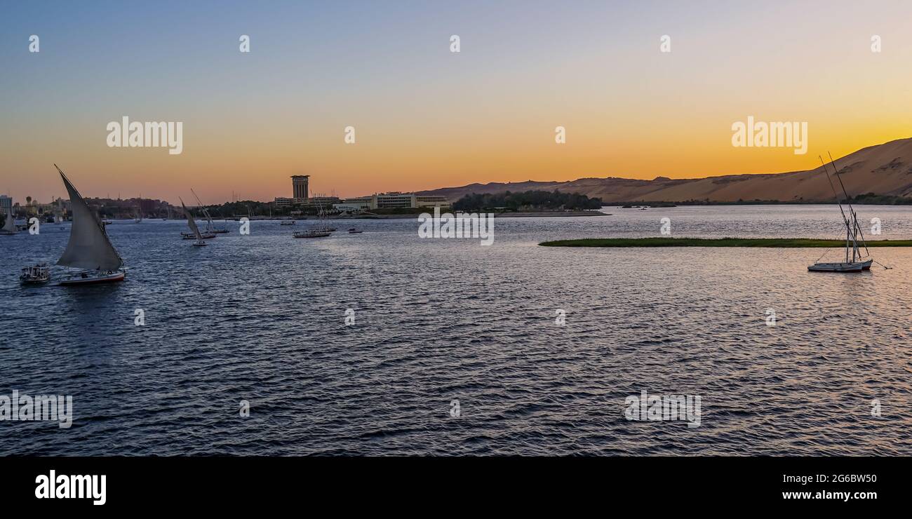 Boats on the Nile River at sunset in Aswan, Egypt Stock Photo - Alamy
