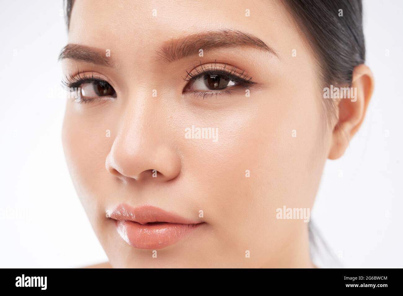 Face of attractive young woman looking at camera with flawless ...