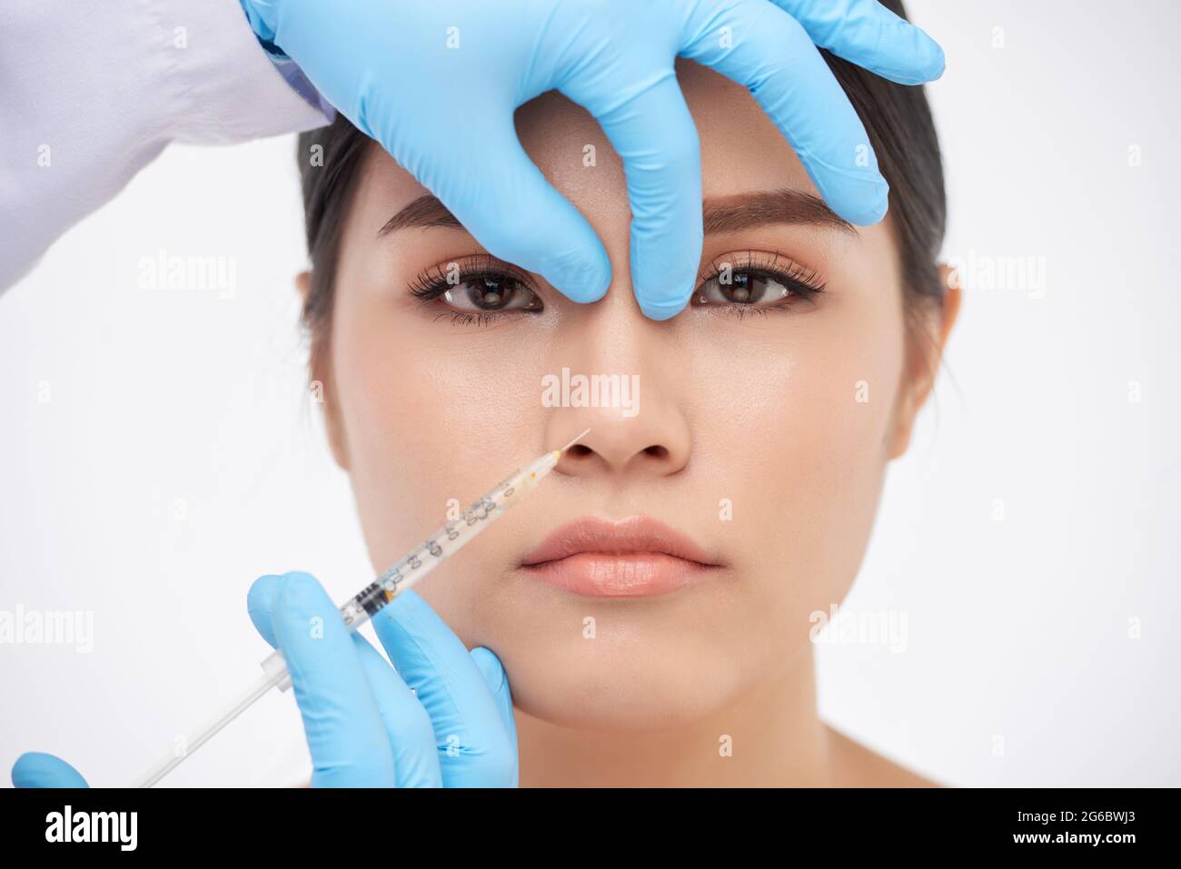 Young woman almost crying when getting painful injection in her nose ...