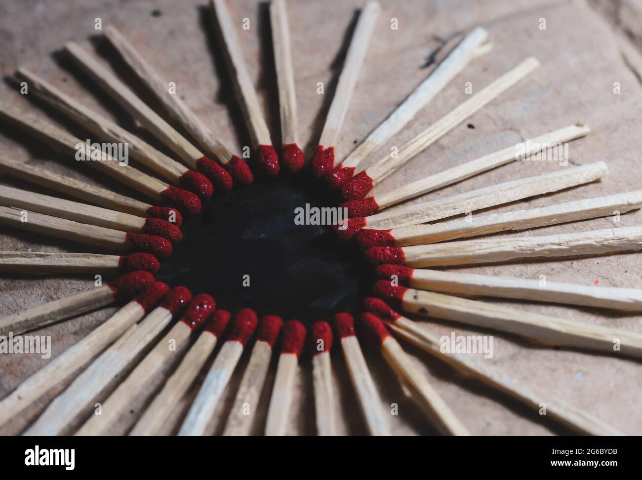 Matchstick with a red heart-shaped head on a wooden background ...