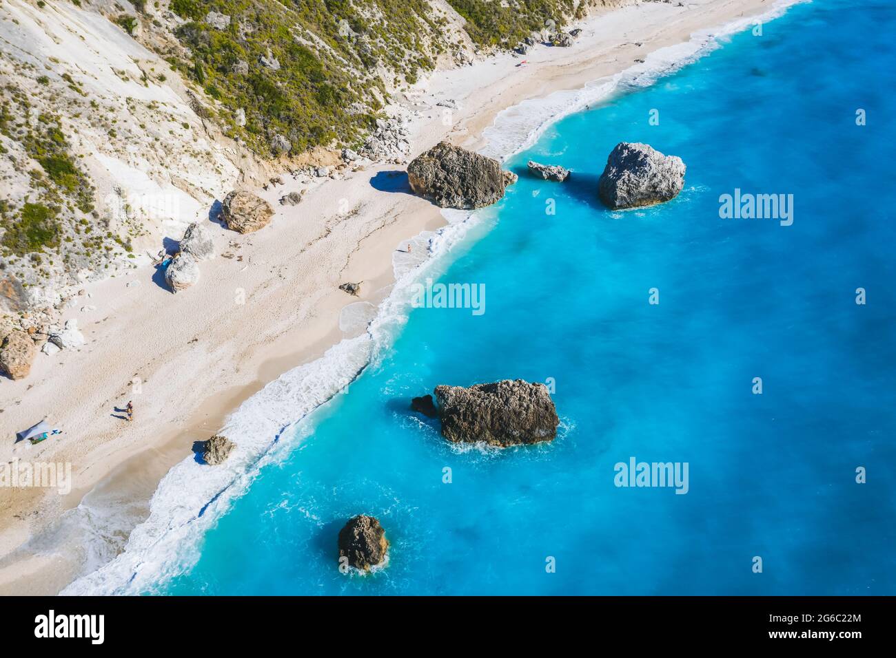 Aerial view of Kalamitsi beach with big boulders in turquoise blue ...