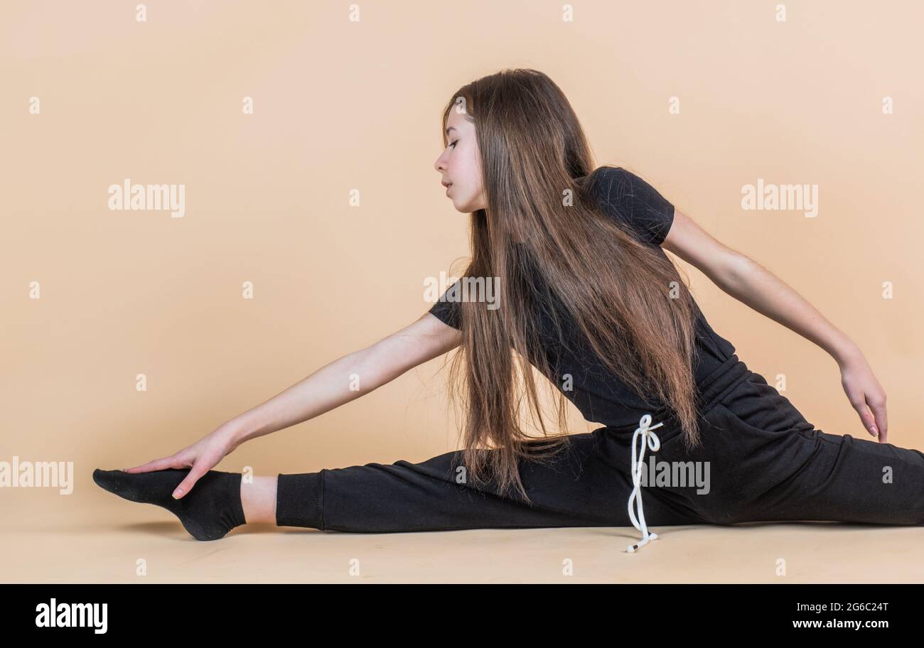 cheerful teen girl sit in split, pilates Stock Photo - Alamy