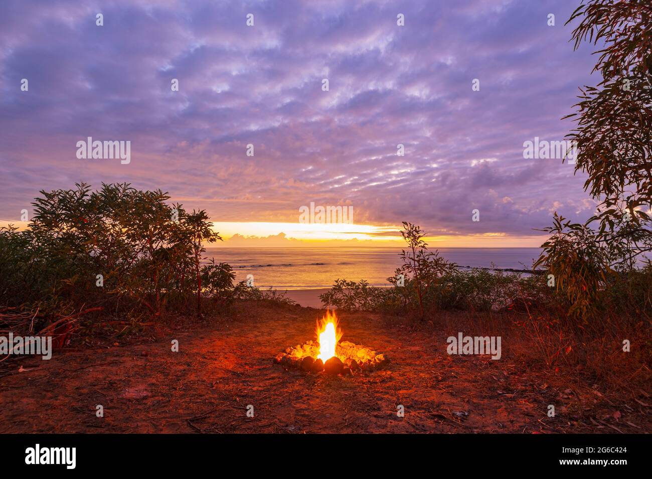 Campfire burning on the beach at sunrise over Pender Bay Escape ...