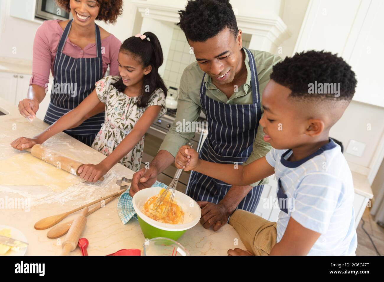 Happy african american parents baking with son and daughter in kitchen ...