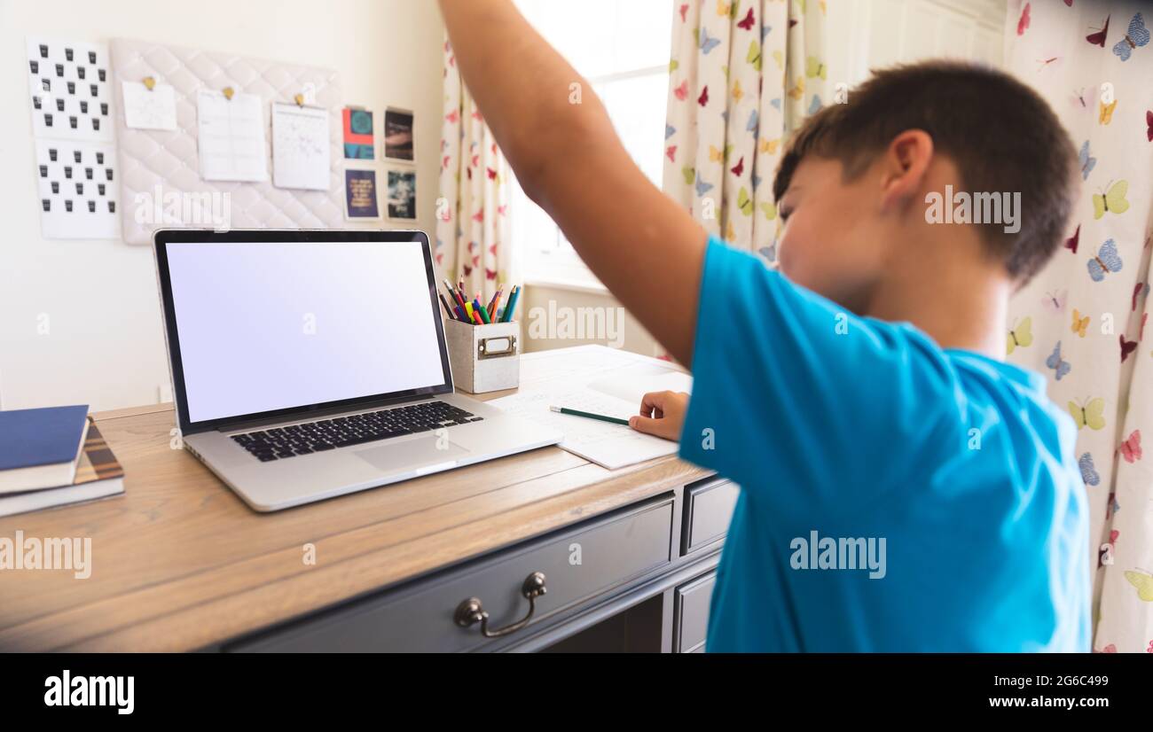 Caucasian boy on video call during class on laptop with copy space and ...