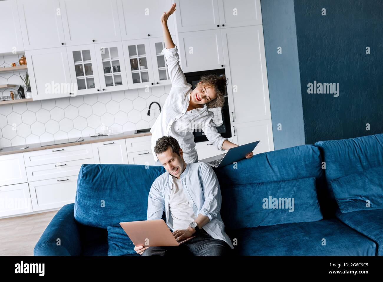 Cheerful young family spouse coworkers, working together at home office ...
