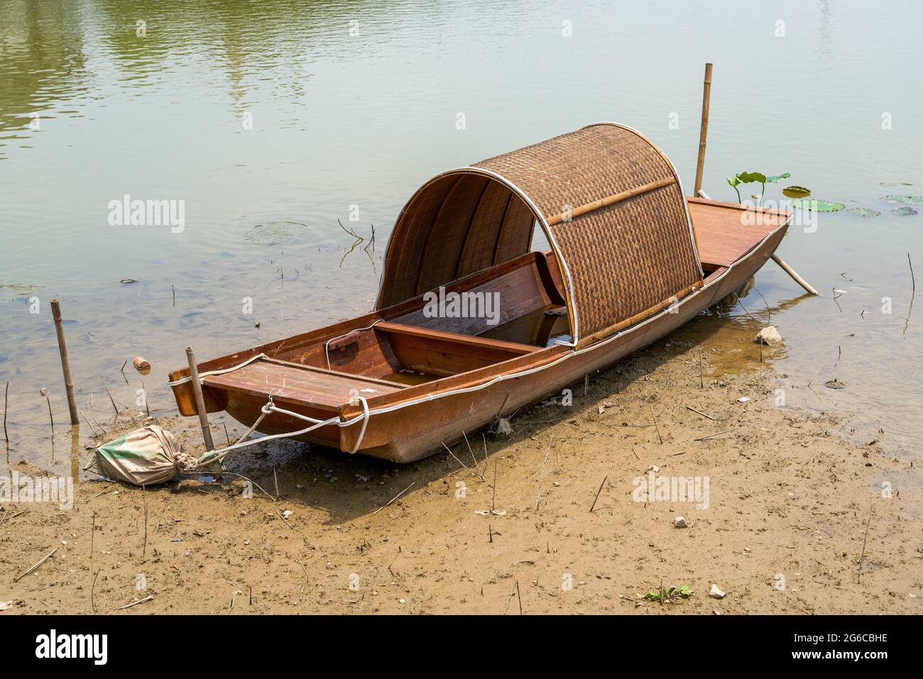 A retro bamboo fishing boat by the river, a boat used by traditional ...