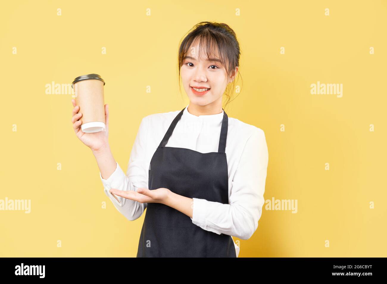 Portrait of cheerful waitress on yellow background Stock Photo - Alamy
