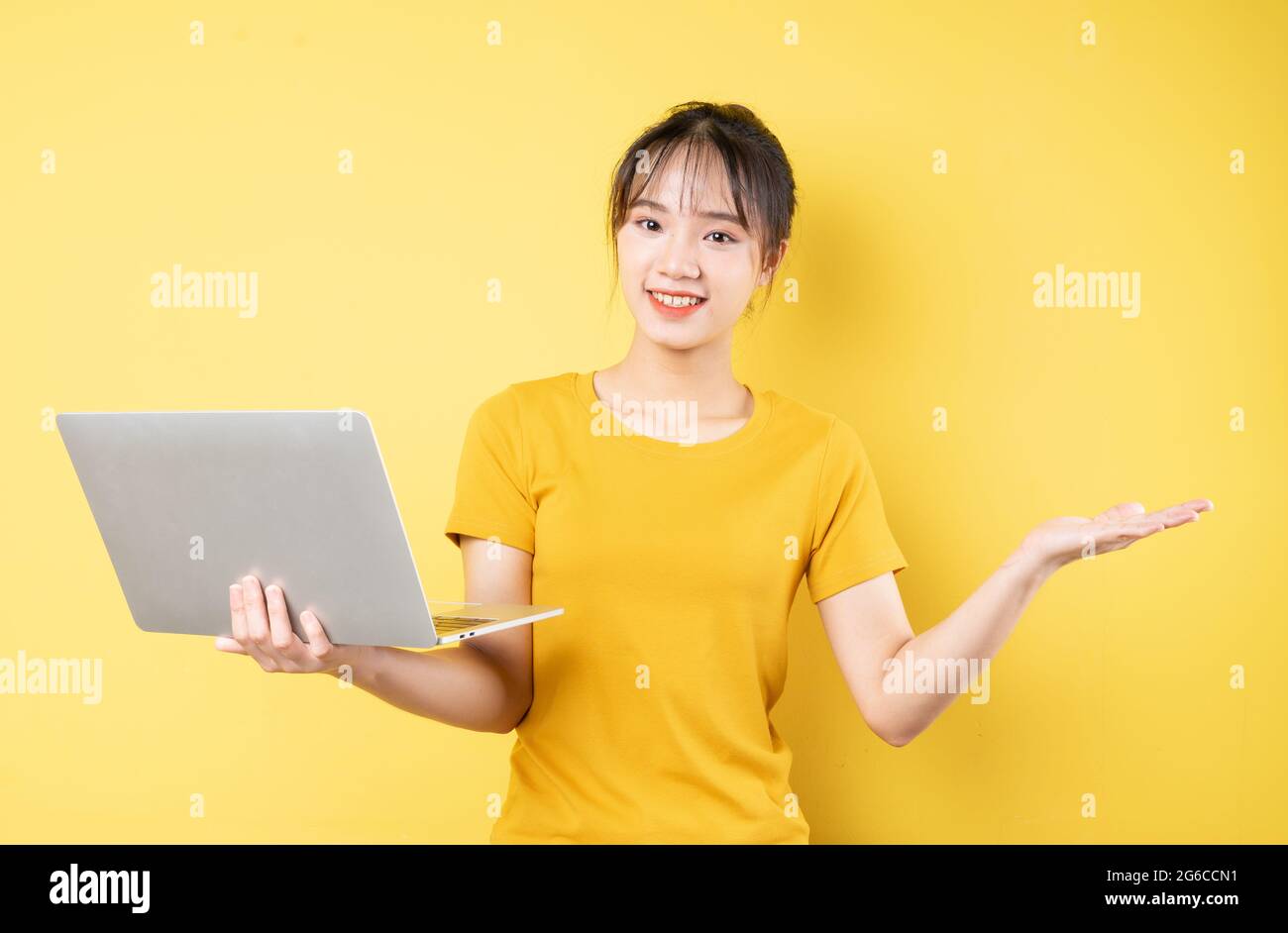 Beautiful girl holding laptop pointing hi-res stock photography and ...