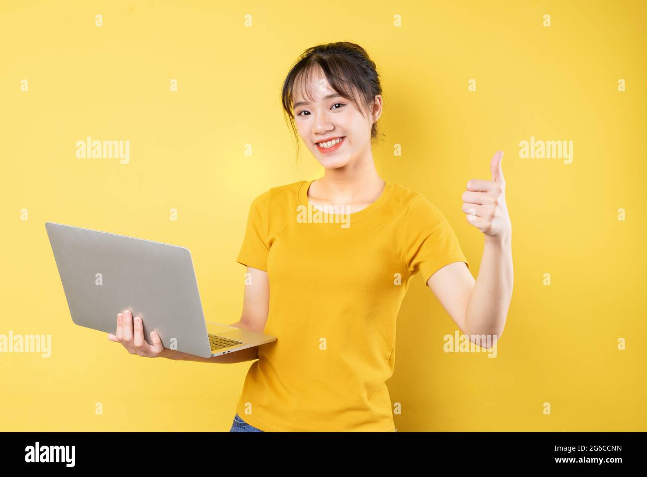 Beautiful girl holding laptop pointing hi-res stock photography and ...