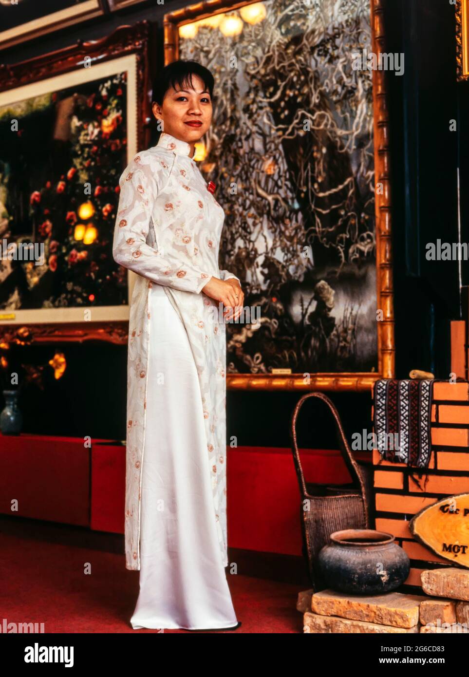 Vietnamese lady wearing ao day in an art gallery, Ho Chi Minh city ...