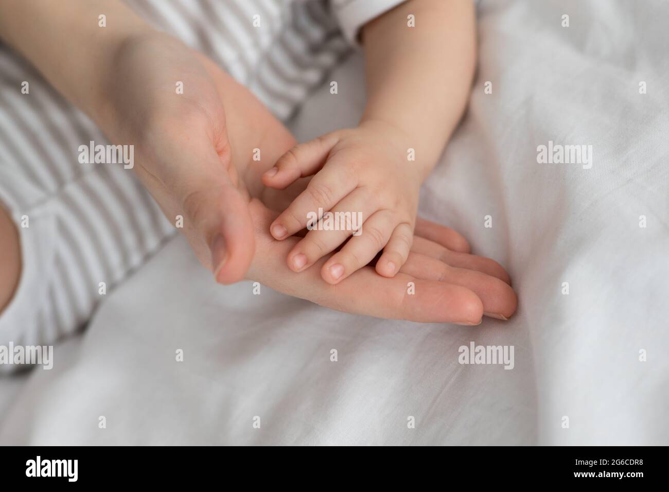 Mother Baby Connection. Mom And Little Newborn Baby Joined Hands ...