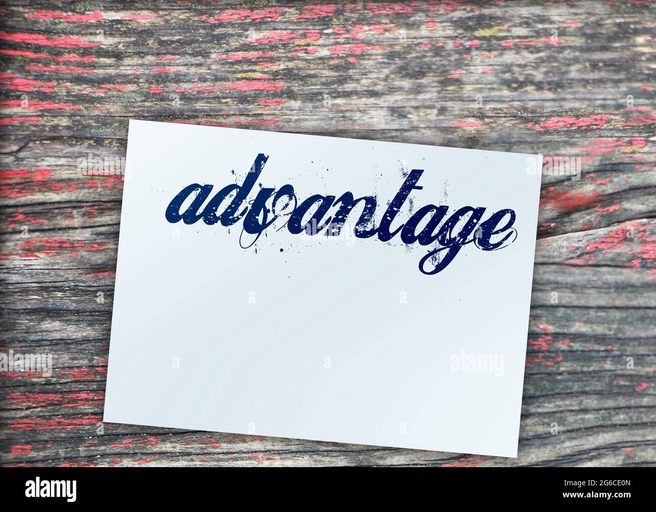 Advantage word on page and paper dollar signs around on wooden table ...