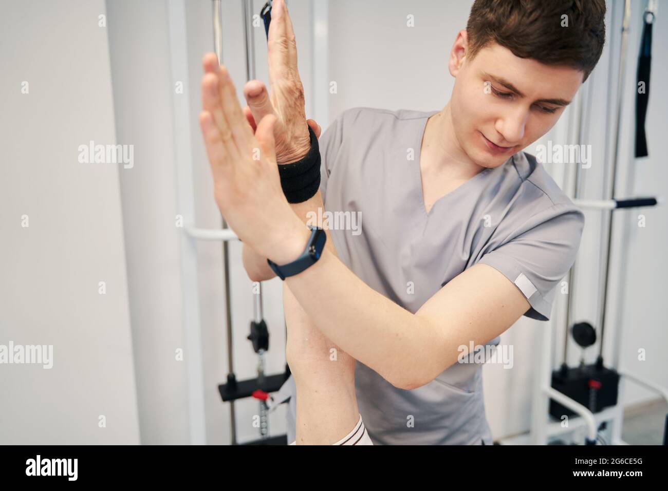 Caring medic demonstrating the way of holding hand during activity ...