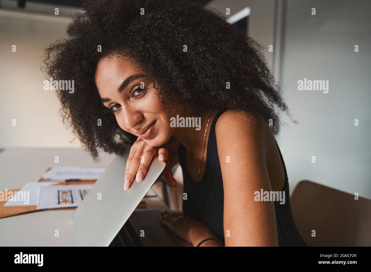 Pretty woman in the office smiling kindly to the camera Stock Photo - Alamy