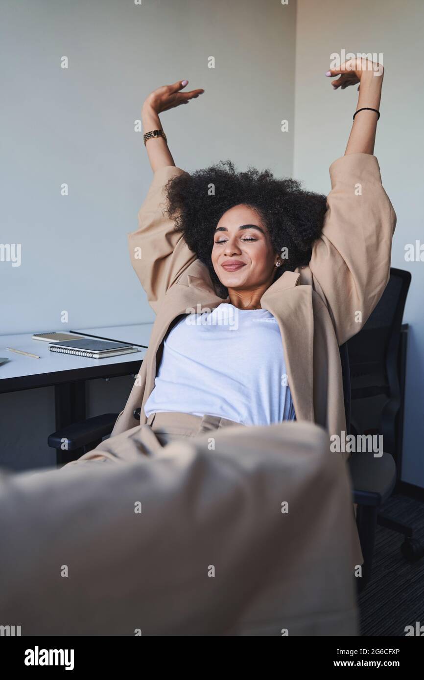 Beautiful office worker feeling good alone and smiling Stock Photo - Alamy