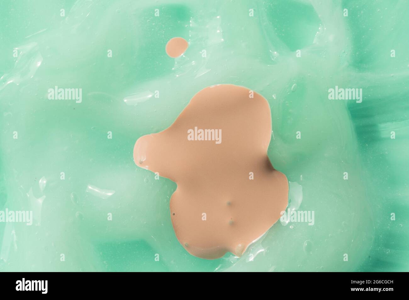 Liquid foundation smear on mint cream textured background. Green creamy ...