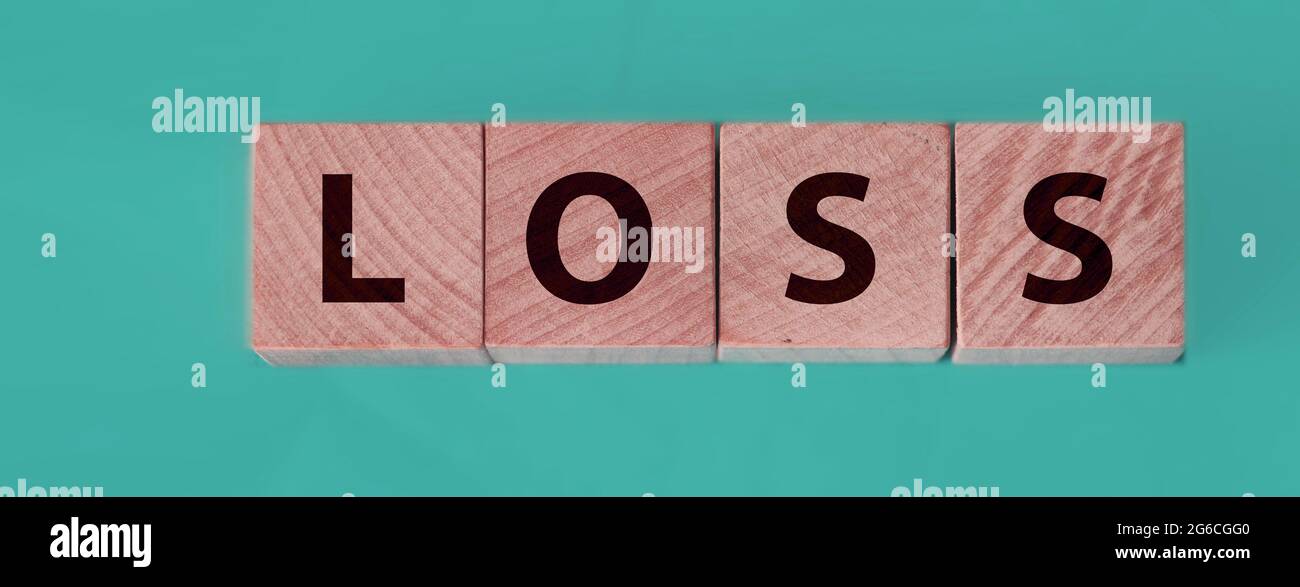 Wooden cubes with LOSS word on sky blue background. Financial loss ...