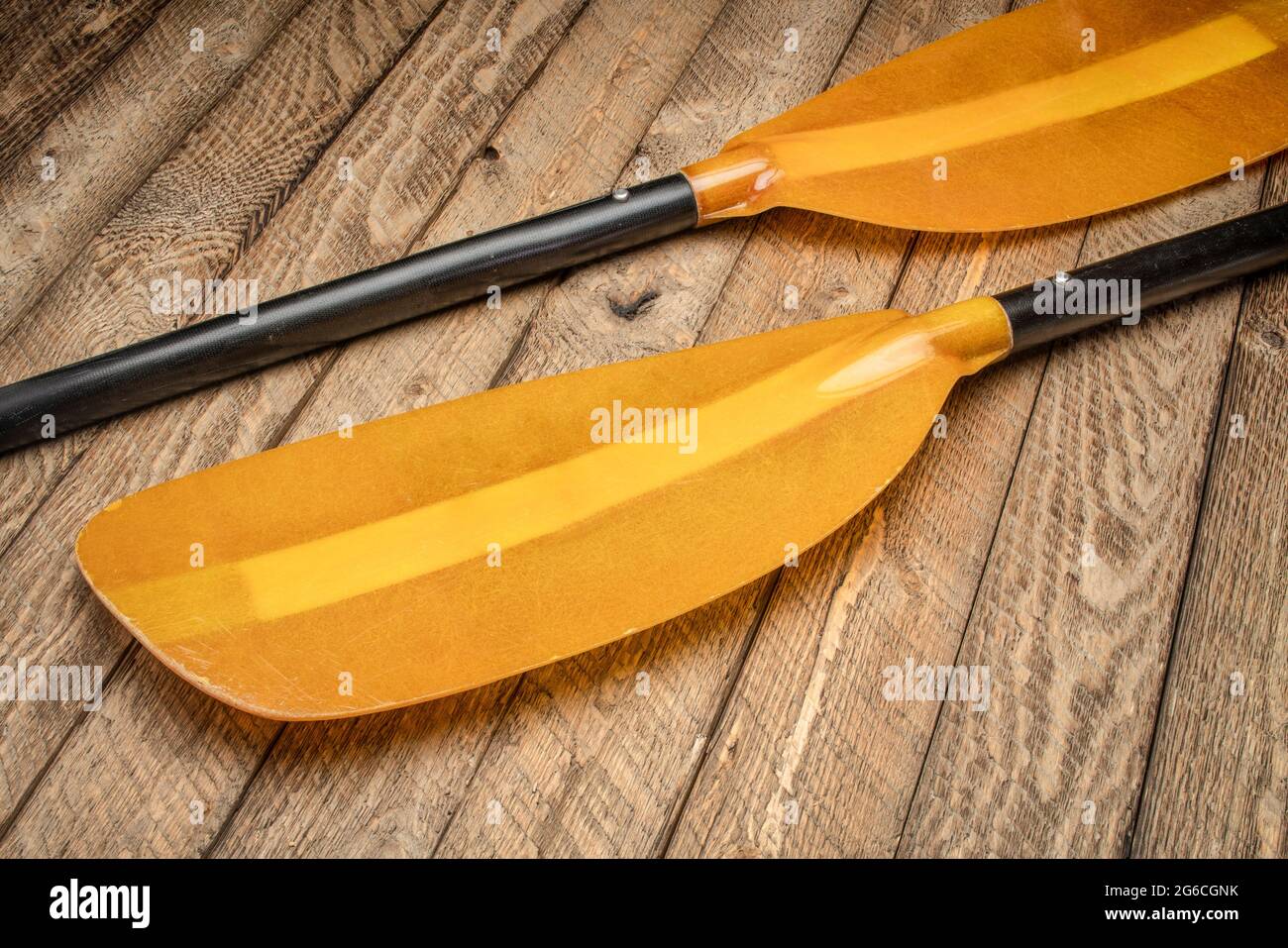 take-apart fiberglass whitewater kayak paddle against weathered wood ...