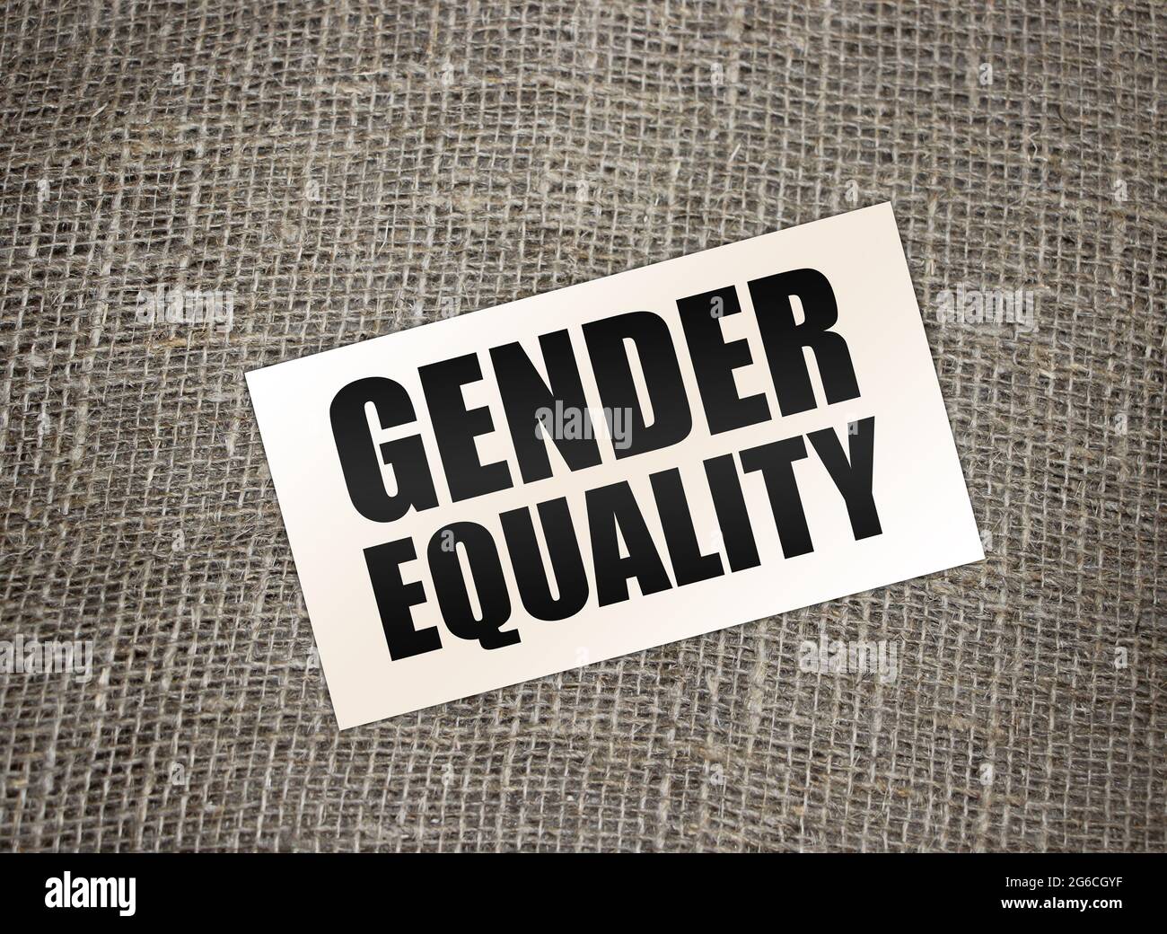 Gender Equality words on card on burlap canvas. Equal rights social ...