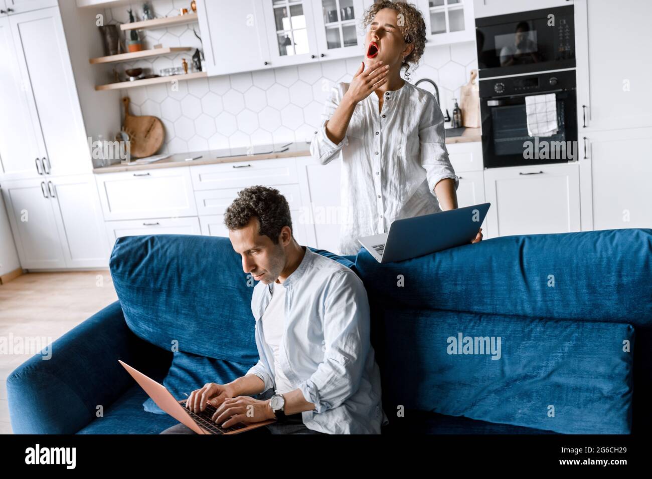 Tired couple laptops on sofa hi-res stock photography and images - Alamy