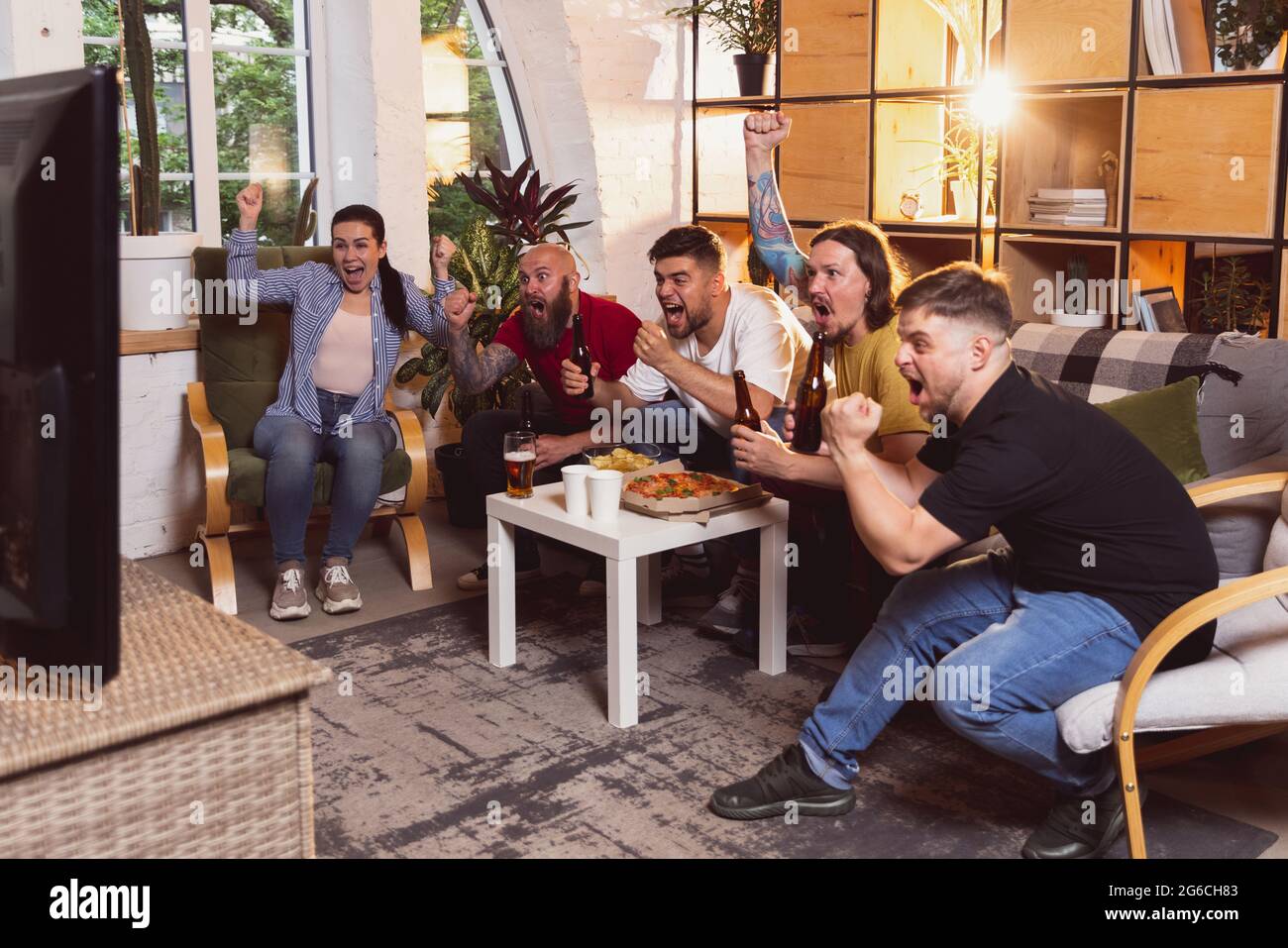 Group of friends watching TV, sport match together. Concept of ...