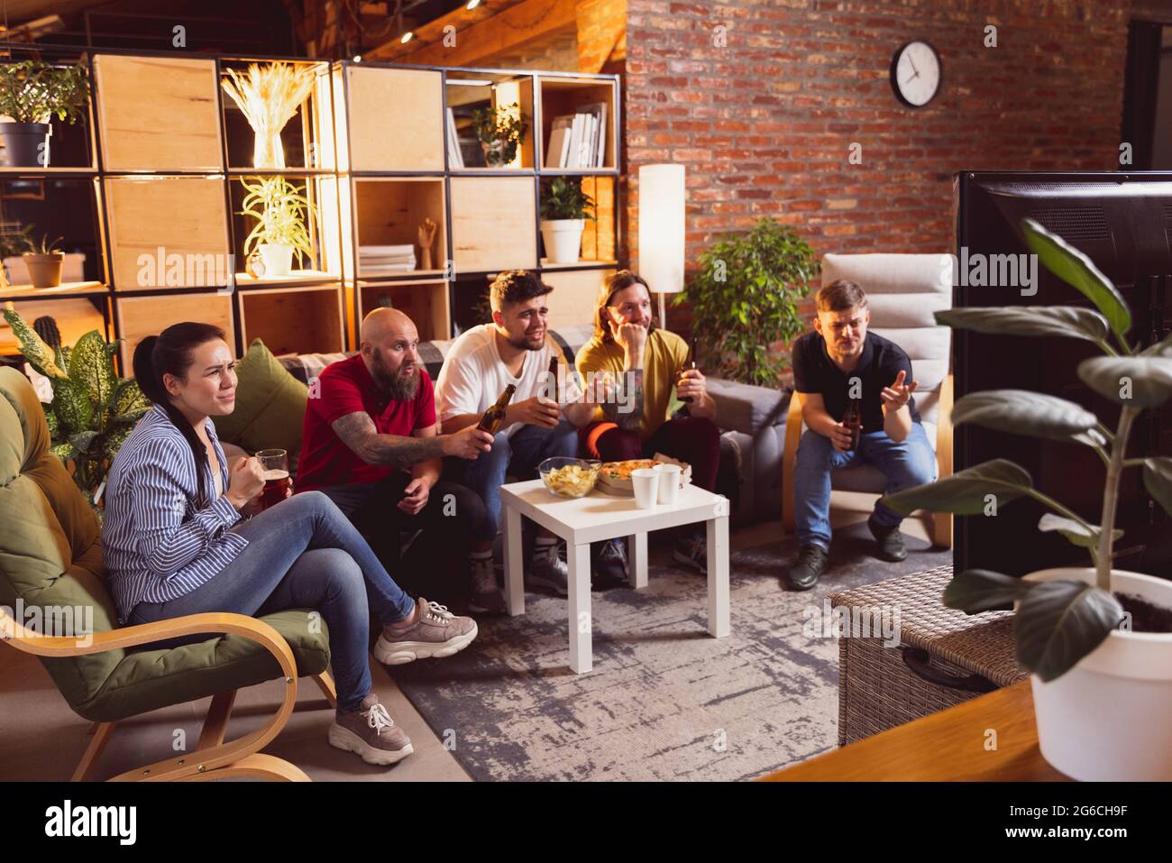 Group of friends watching TV, sport match together. Concept of ...