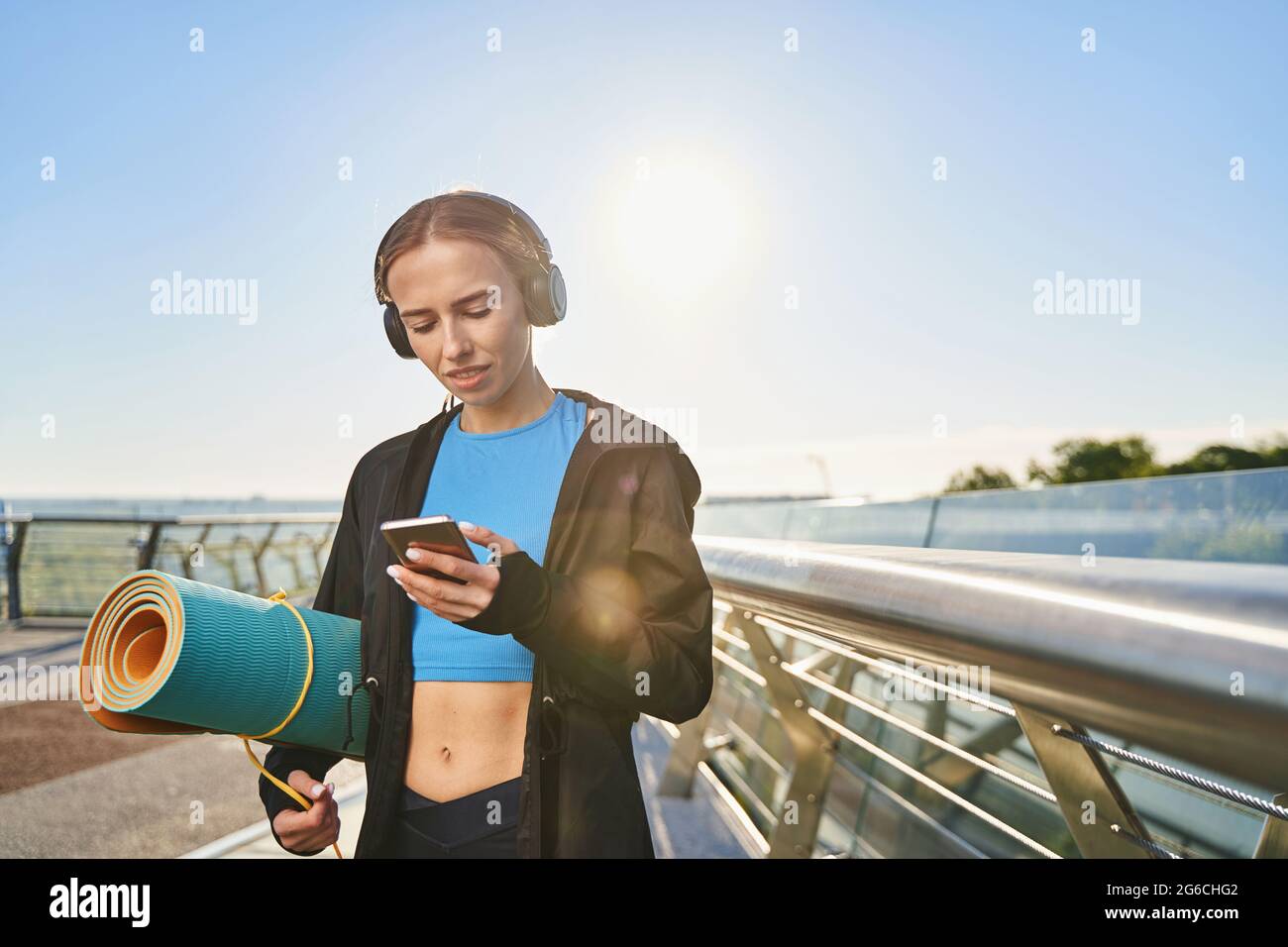 Female using gadgets during training in open air Stock Photo - Alamy