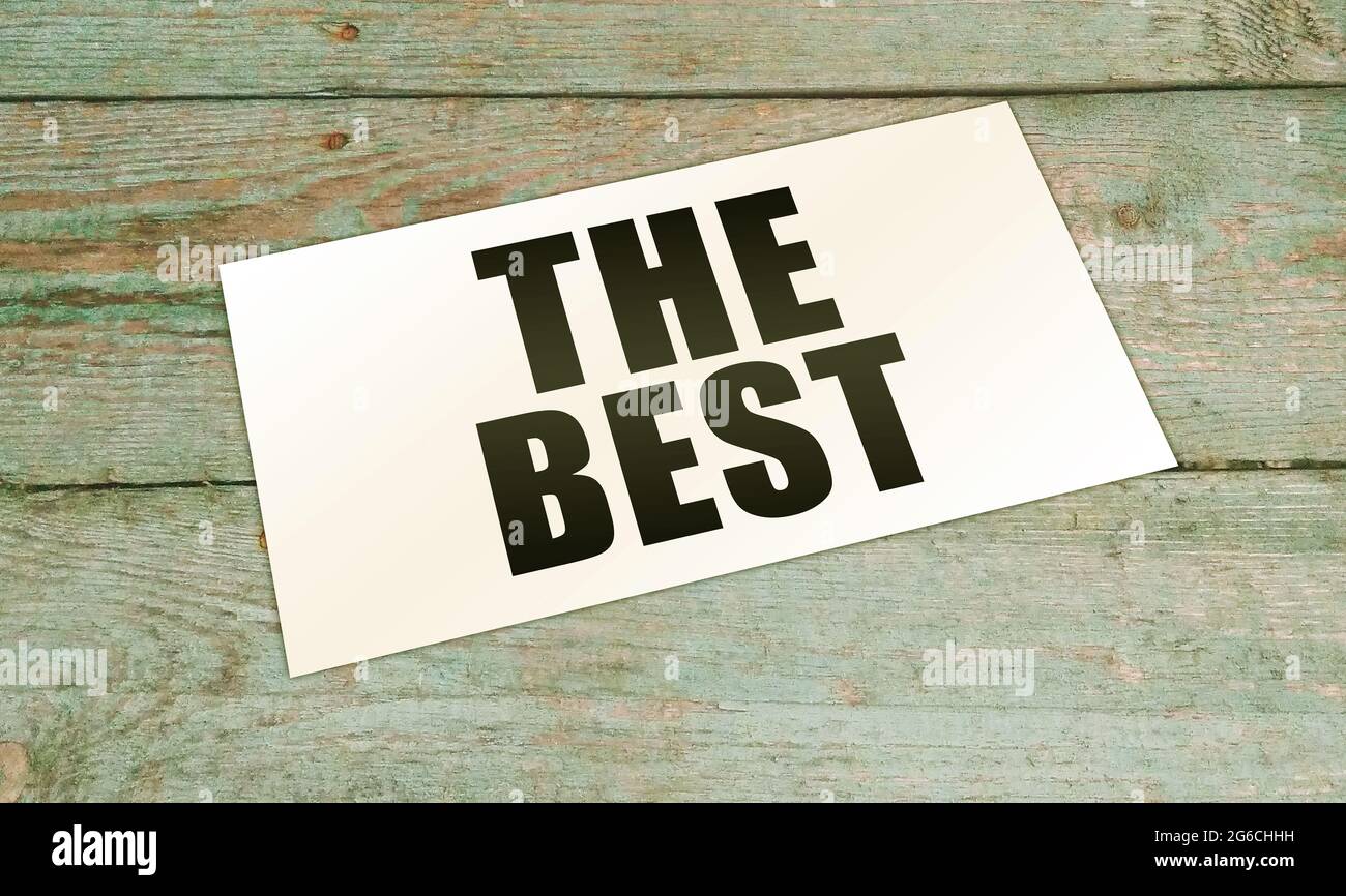 card with text The Best on wooden table. business concept Stock Photo ...