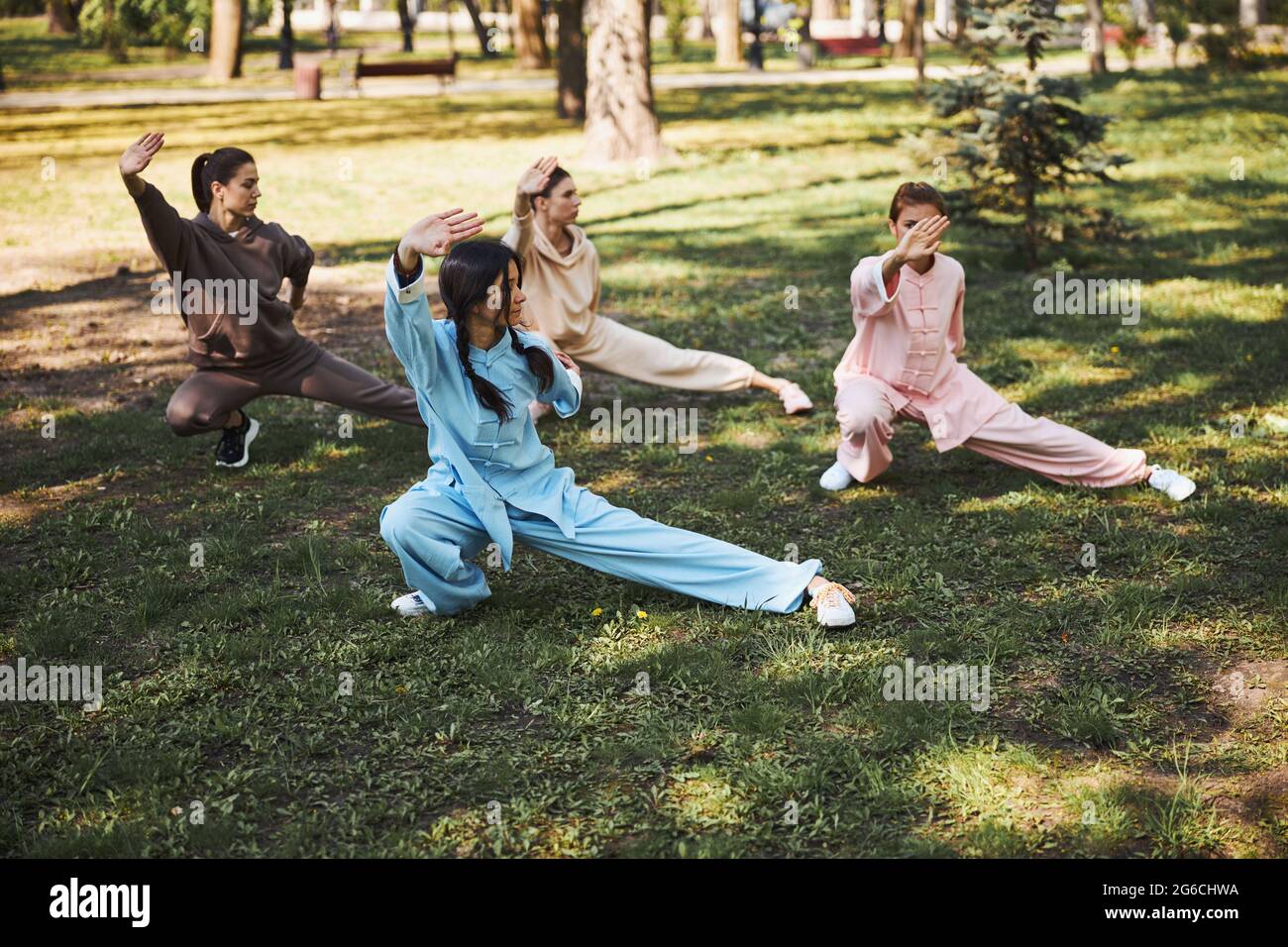 Women showing snake creeps down pose during outdoor class Stock Photo ...
