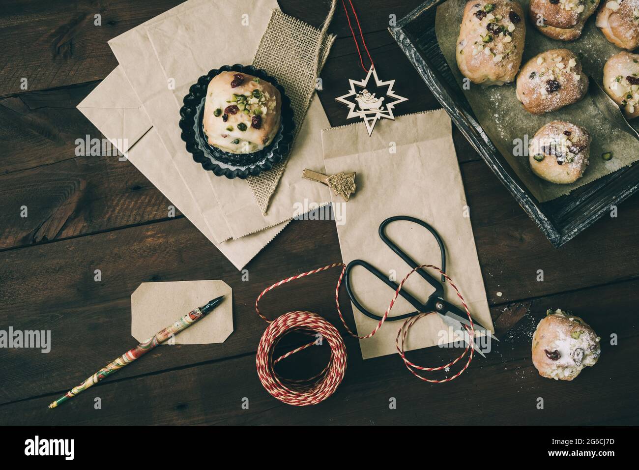 Scene for gifts in Advent with mini stollen, paper bags, scissors, pen ...
