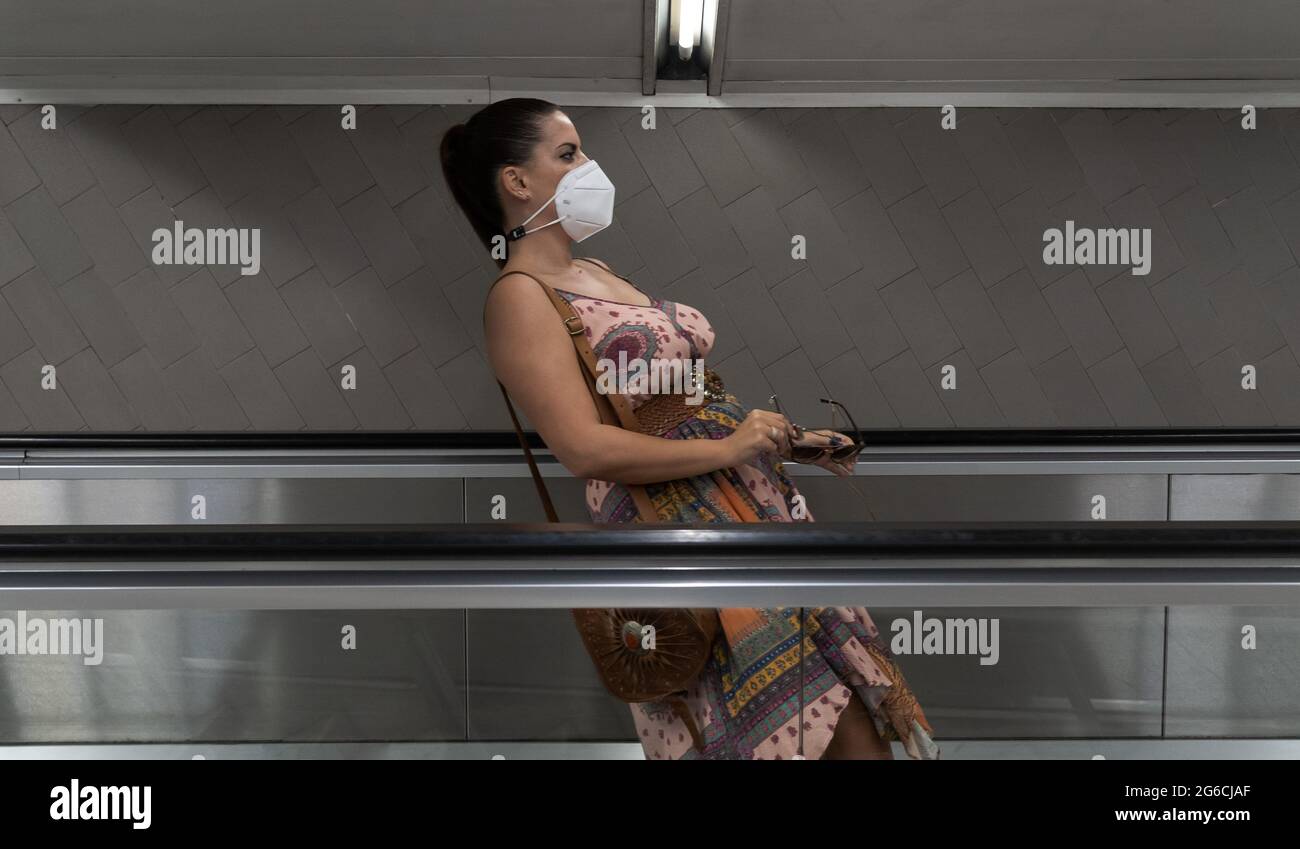 Perspective effect of a young woman with a face mask in a leaning ...