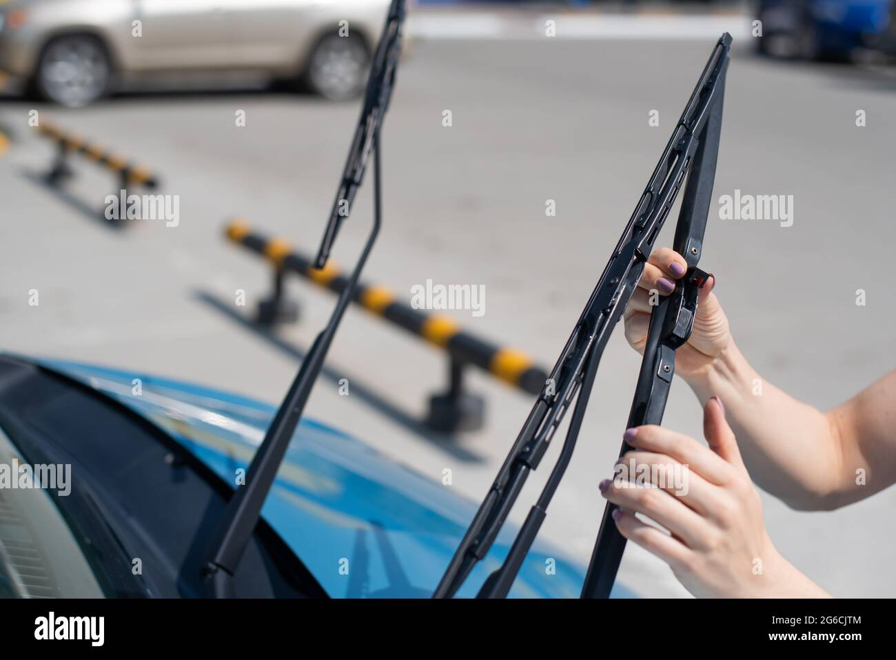 Faceless woman changing car windshield wipers Stock Photo - Alamy